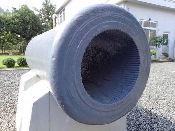 A family gazes at a turret salvaged from the wreck of the battleship ...